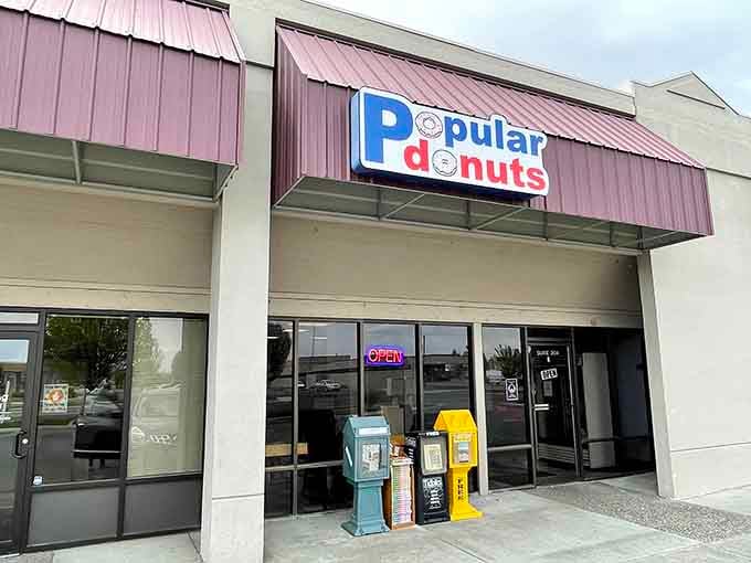 The cheerful signage practically shouts "come on in" with vintage newspaper boxes standing guard like loyal sentries outside.