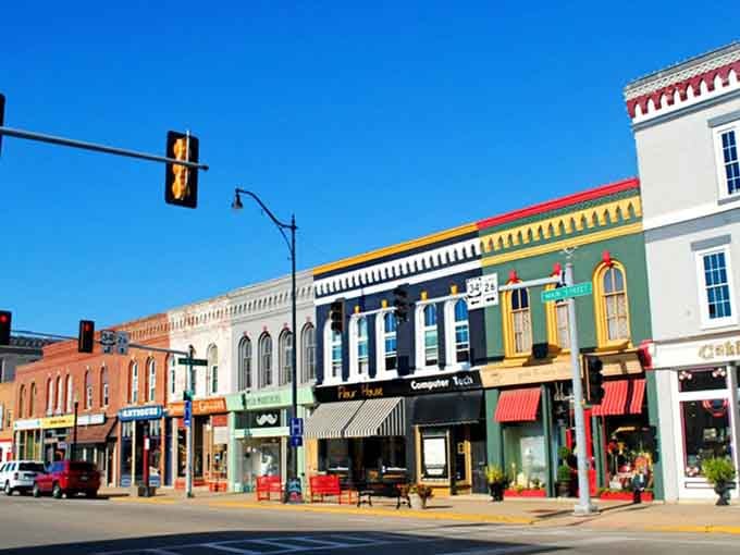 Colorful awnings pop against historic facades like confetti celebrating the joy of independent local businesses thriving here.