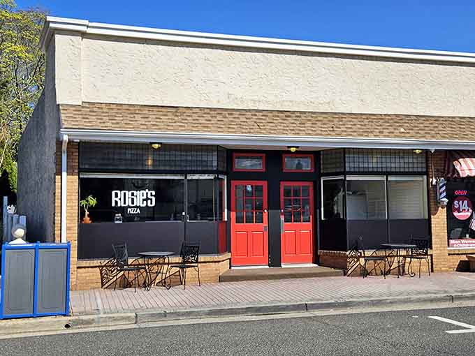Those bold red doors pop against the white facade like a cheerful greeting from your favorite Italian grandmother.