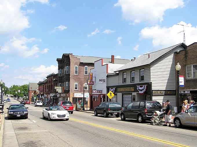 Salem&rsquo;s main street hums gently, classic storefronts, passing cars, and everyday moments blending into a warm, welcoming Ohio small-town scene.