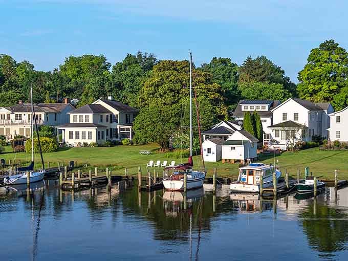 Boats bob peacefully at their docks while classic homes overlook the water, creating a scene unchanged for generations.