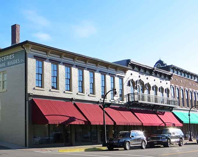 Red awnings shade storefronts that have welcomed shoppers since your grandparents' grandparents were buying penny candy inside.