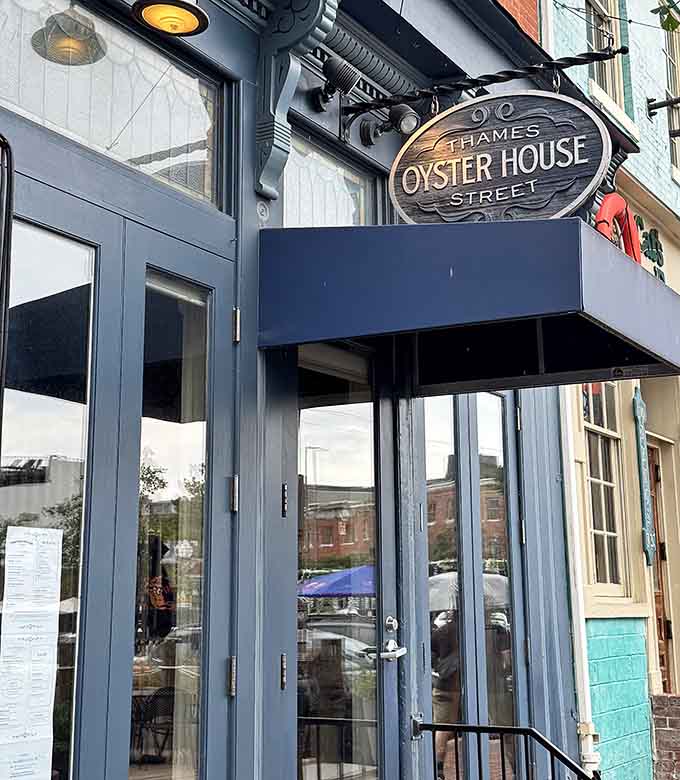 The elegant storefront sign hangs like a promise of briny delights waiting just beyond those glass doors.