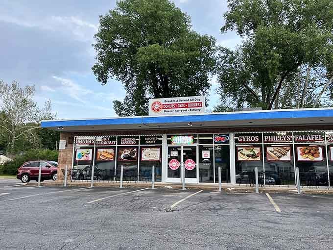 That blue awning shelters more than just donuts—it's a neighborhood gathering spot with serious breakfast credentials.