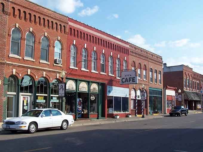 Arched windows march along this brick facade like soldiers standing guard over a century of small-town stories and secrets.