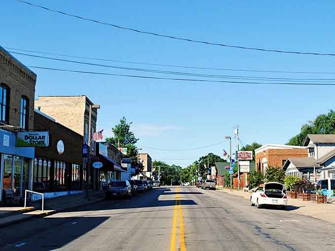 The Dollar Store sign and classic brick facades show a town that balances practical needs with old-fashioned character beautifully.