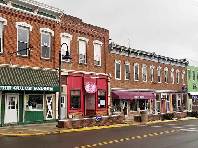 The Gulch Saloon's bright red facade pops against neighboring buildings like a cherry on top of history.