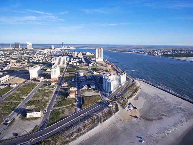 The Atlantic stretches endlessly beyond the shoreline, where casino towers stand guard over sandy beaches and boardwalk dreams.