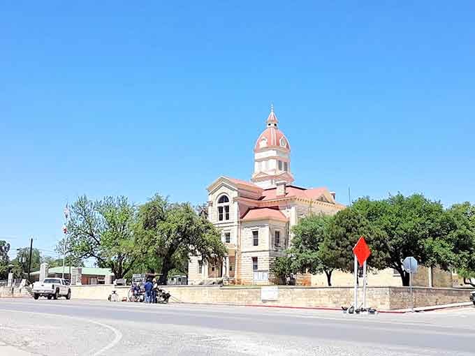 That pink-domed courthouse surrounded by ancient oaks looks like something from a European postcard that wandered into Texas by mistake.