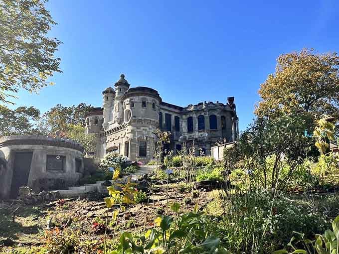 Nature reclaims the castle grounds where wildflowers now bloom between weathered stones and forgotten garden paths.