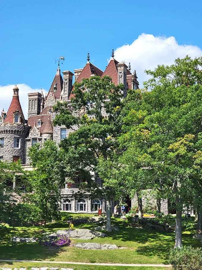 The red-tiled peaks rising above lush gardens create a scene that belongs on a fancy chocolate box cover.