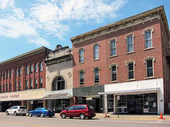 Brick facades stand shoulder-to-shoulder like old friends who've weathered every storm together and refuse to budge now.