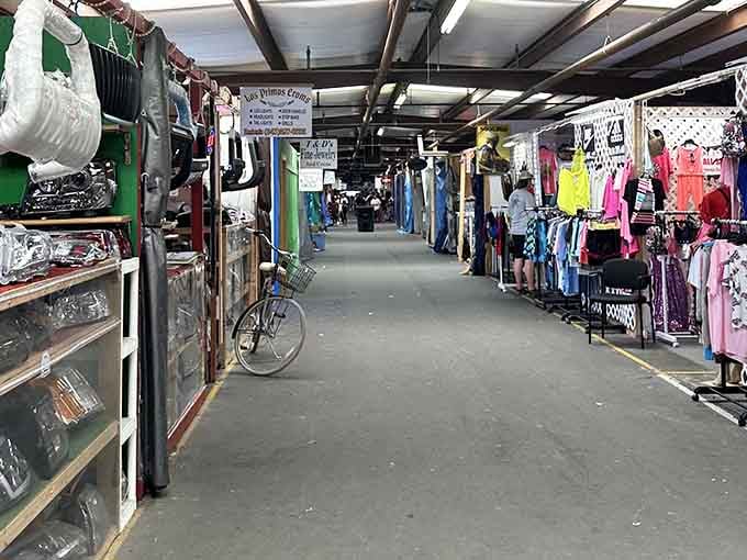 Colorful clothing racks line both sides of this wide aisle, creating a rainbow of shopping opportunities.
