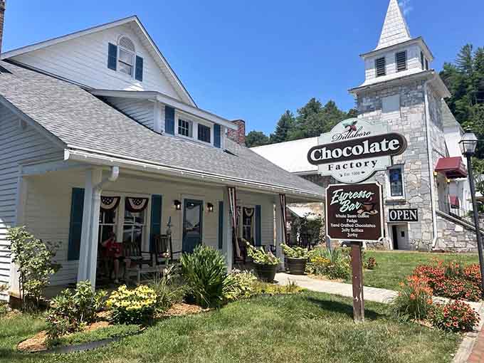 Sunshine and fresh flowers frame the entrance where handcrafted chocolates await behind those welcoming blue doors.