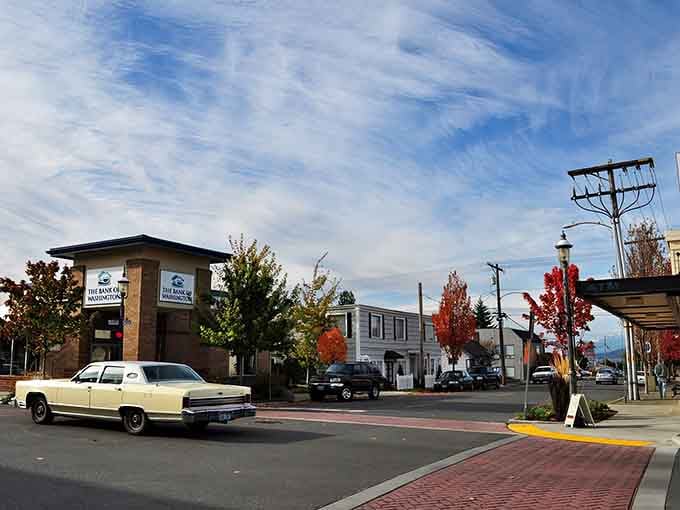 That vintage cream-colored sedan adds a touch of nostalgia to streets where autumn colors paint the perfect walking backdrop.