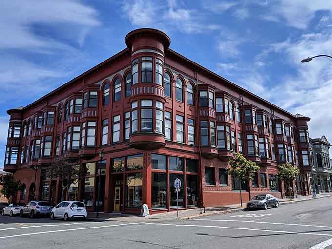 The ornate corner building commands attention with its bay windows and architectural details that modern construction forgot.