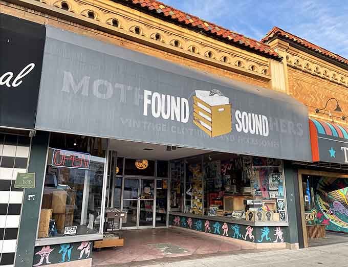 Golden afternoon light bathes this storefront, making those colorful dancing figures practically boogie right off the glass.