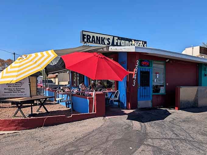 Those cheerful striped umbrellas and bright blue tables create the perfect casual outdoor dining atmosphere.