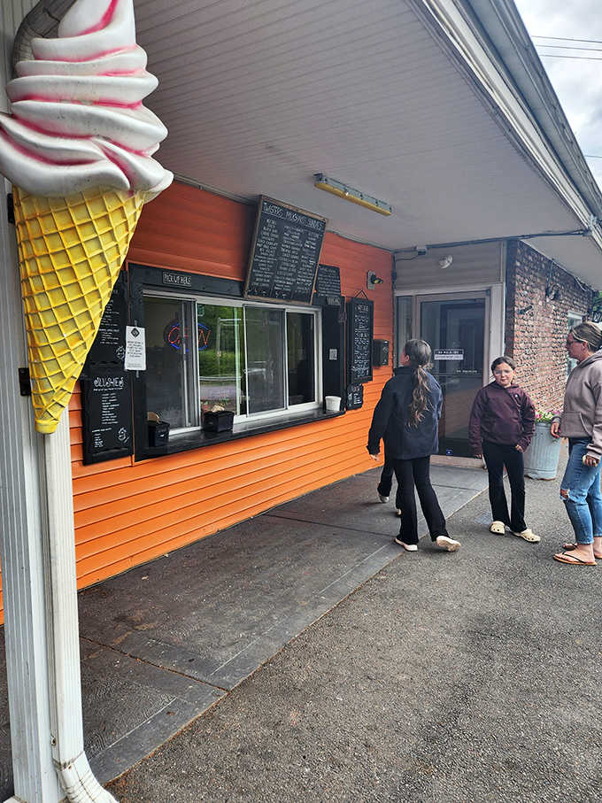 The oversized cone sculpture promises exactly what's inside: perfectly swirled soft serve worth the inevitable line.