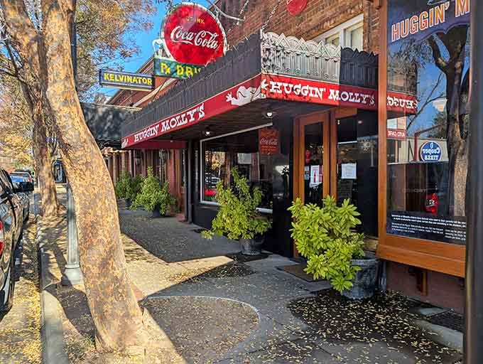 Vintage signage and potted plants create Main Street magic where local legends come alive with every meal.