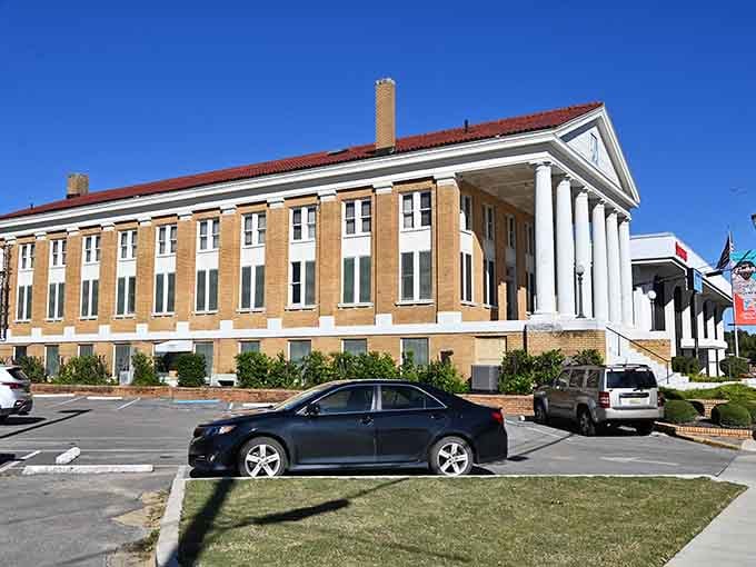 Those grand white columns frame a courthouse that looks like it stepped straight from a classic movie set.