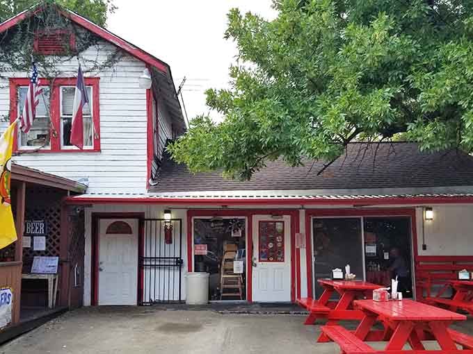 The white clapboard building with red trim looks like a cozy neighborhood spot where everyone knows your name.
