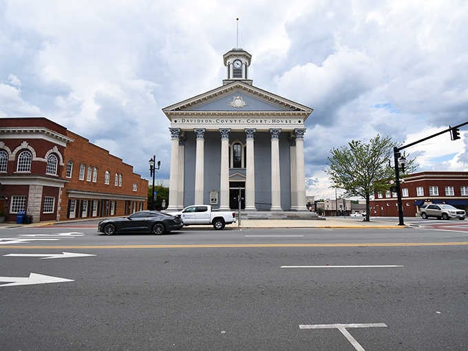 Grand courthouse columns stand watch over a town square where barbecue smoke has drifted for longer than anyone remembers.