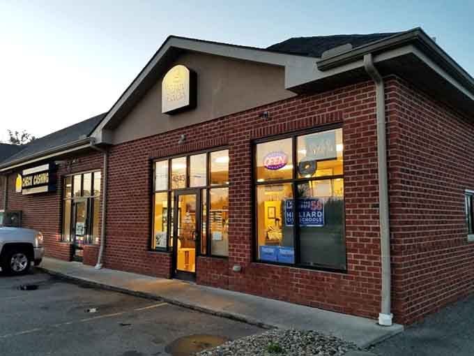Golden hour light bathes this brick building, making it glow like the warm donuts waiting inside for early birds.