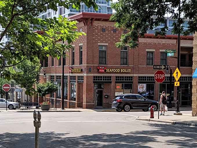 Classic brick storefront meets modern street scene, where Mad Seafood Boiler transforms ordinary evenings into messy, delicious celebrations.