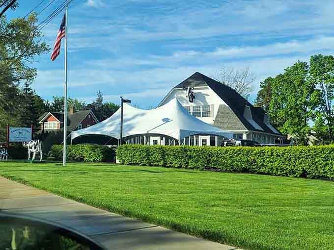 The manicured lawn and white tent setup prove this place takes outdoor dining as seriously as their home cooking.