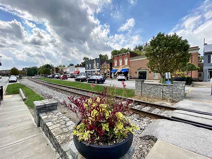 Vibrant planters and stone walls frame the tracks, turning functional infrastructure into an Instagram-worthy garden path you'll remember.