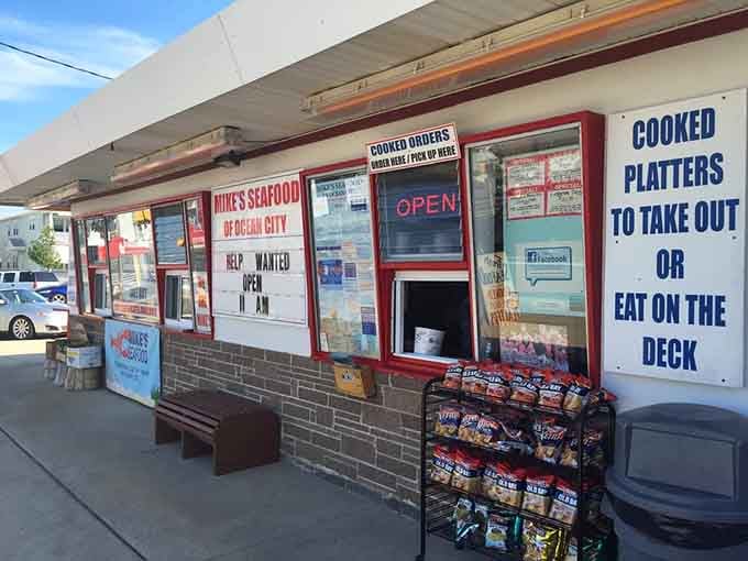 Those cheerful window signs promise cooked platters and deck dining, making this the ultimate casual coastal experience you crave.