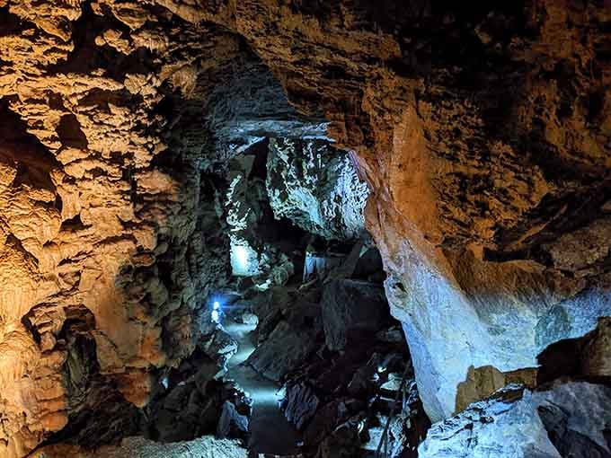 Dramatic lighting reveals the sculpted passages where water carved art galleries through solid marble over millennia.