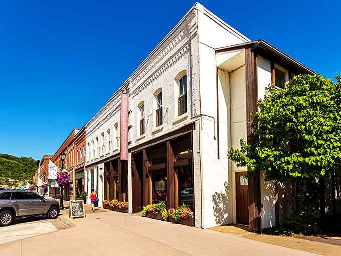 Historic storefronts line walkable streets where flower baskets add charm and locals still greet passing strangers warmly.