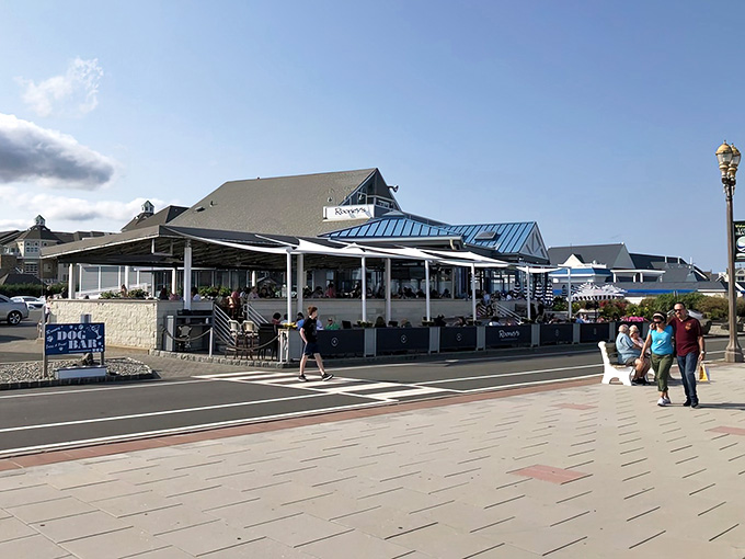 The covered outdoor dining area buzzing with happy guests captures that perfect summer evening vibe we all crave by the water.