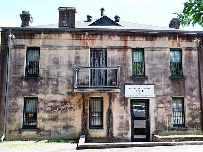 The Old Jail's facade wears its age like a badge, each stain and crack whispering tales of justice past.