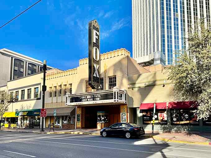 The vintage Fox Theatre marquee glows against Spanish Colonial Revival architecture, blending old Hollywood glamour with desert charm.