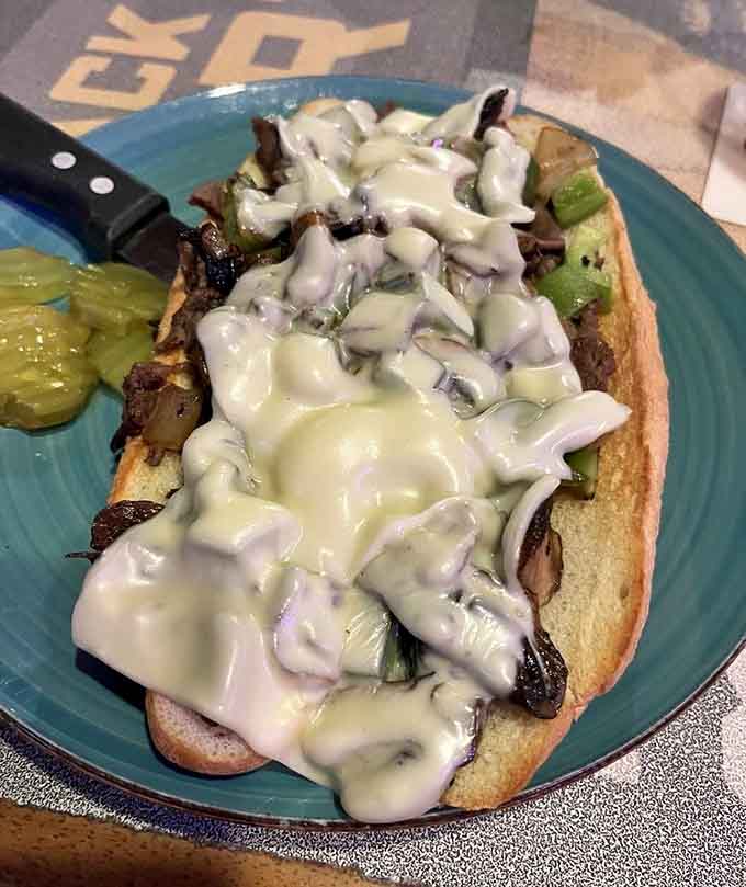 Provolone cascading over tender steak on a toasted roll is pure sandwich poetry in motion.