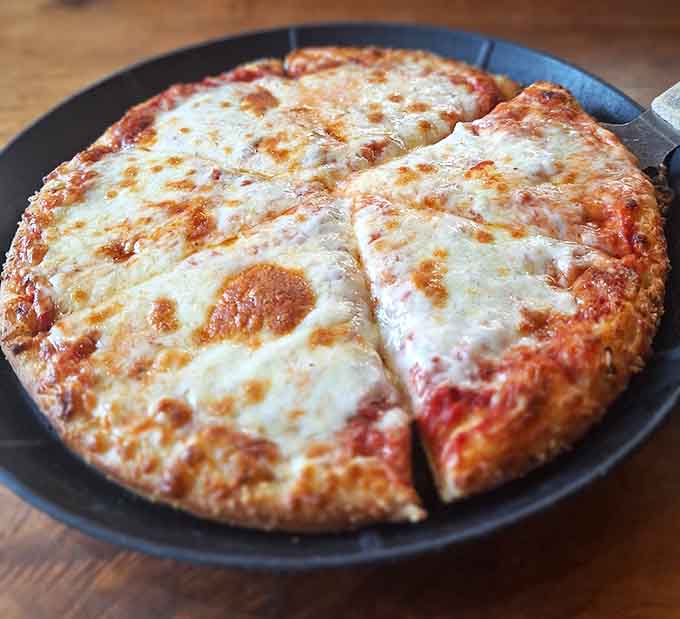 Sometimes simple cheese pizza is all you need, golden and bubbling like edible comfort in a pan.