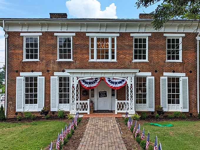 Patriotic bunting and pristine white trim on red brick whisper stories of American history worth hearing.