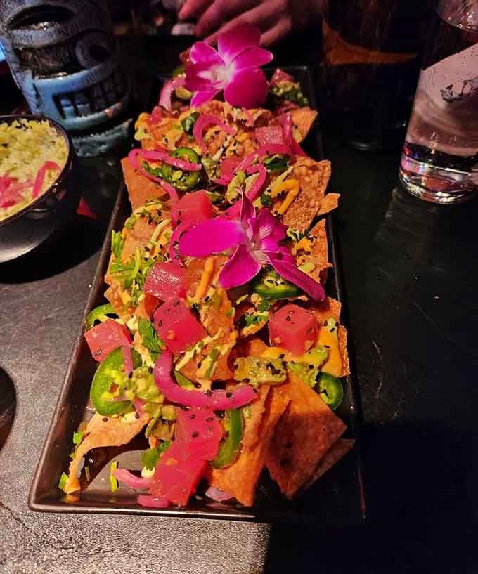 Nachos topped with ahi tuna and enough colorful garnishes to make a sunset jealous of its presentation game.