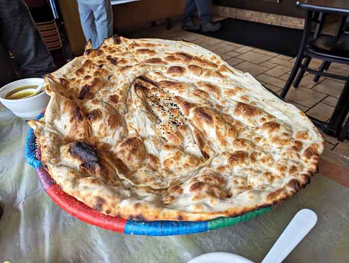 That's not a regular flatbread, that's practically a tablecloth of deliciousness begging to be torn and shared.