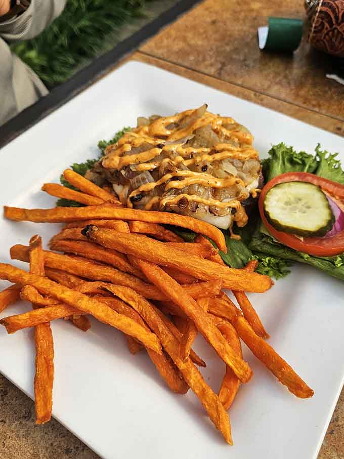 That burger's got more toppings than a Christmas tree, and those sweet potato fries deserve their own fan club.