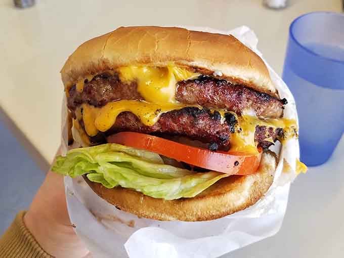 This cheeseburger requires architectural planning and possibly a structural engineer to eat properly without incident.