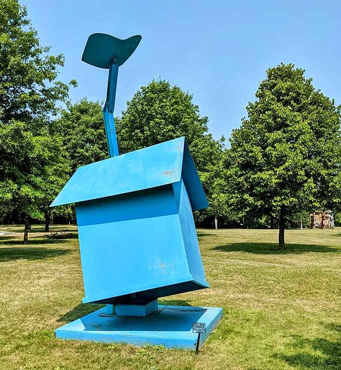 A bright blue geometric sculpture stands proud, looking like it escaped from a modern art museum's fever dream.