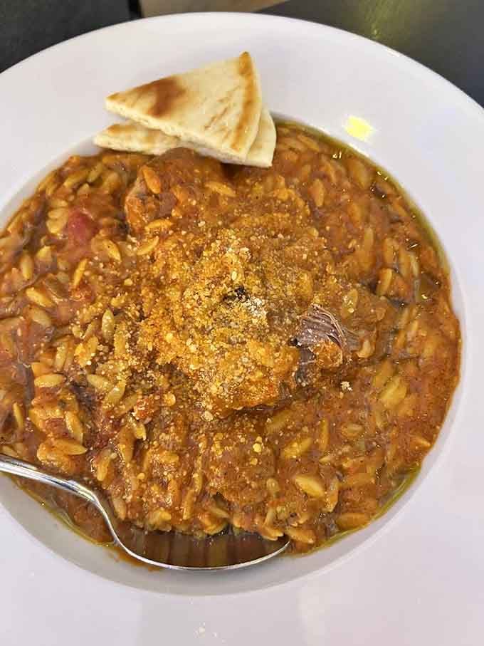 Slow-cooked lamb with orzo in tomato sauce, because sometimes the Greeks just show off their culinary superpowers without even trying.