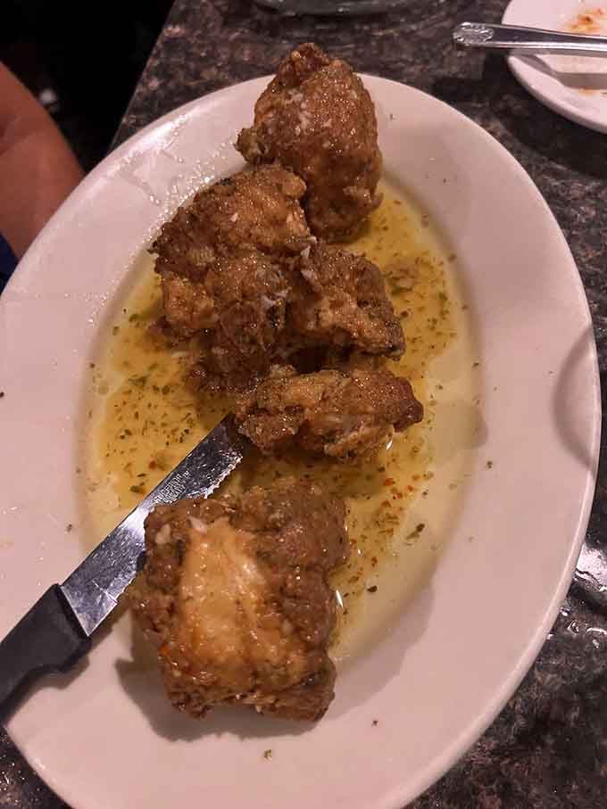 Golden-brown chicken spiedini swimming in garlic-lemon sauce proves skewers aren't just for backyard barbecues anymore.