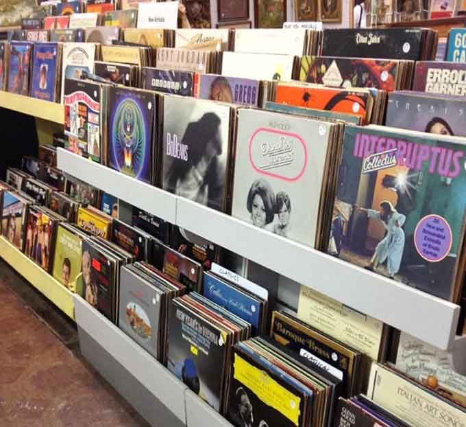 Vinyl records lined up like soldiers, ready to remind you what music sounded like when album art actually mattered.