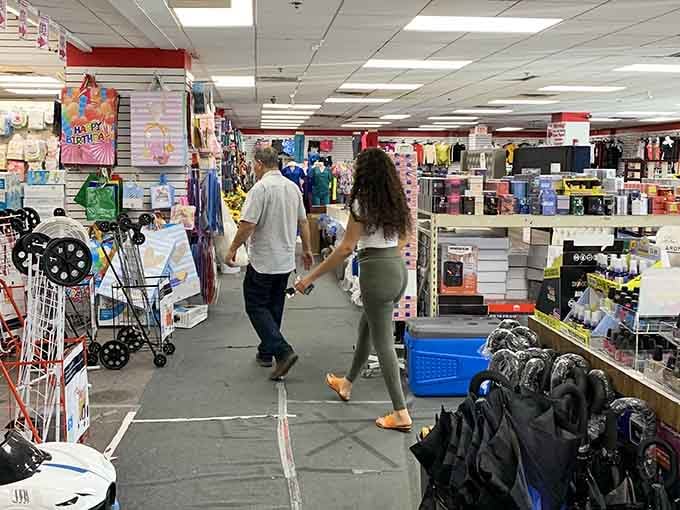 Two shoppers discovering that holding hands while bargain hunting is the ultimate romantic gesture in modern times.
