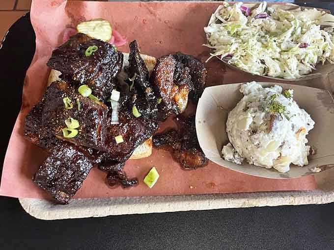 This platter of burnt ends and sides is what happiness looks like when served on butcher paper.